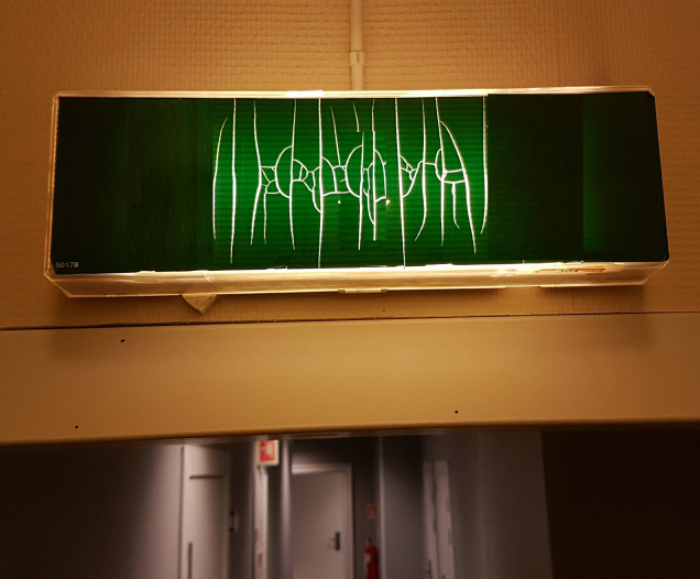This damaged exit sign in Norway looks like a Norwegian metal band logo ...